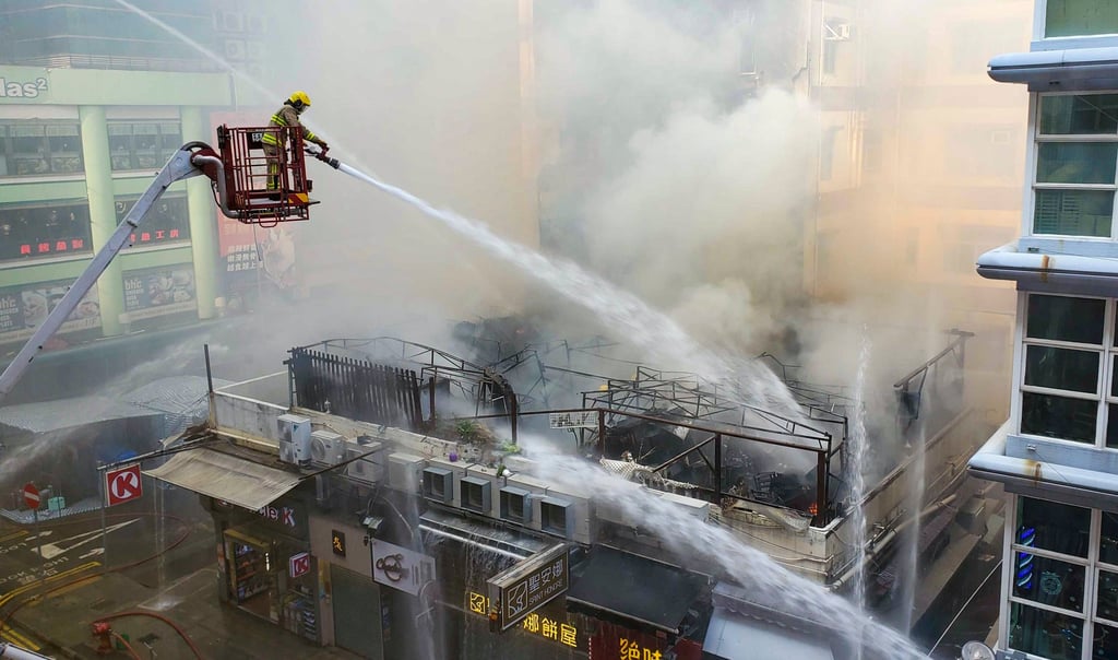 92 people evacuated after fire breaks out at podium of Hong Kong ...