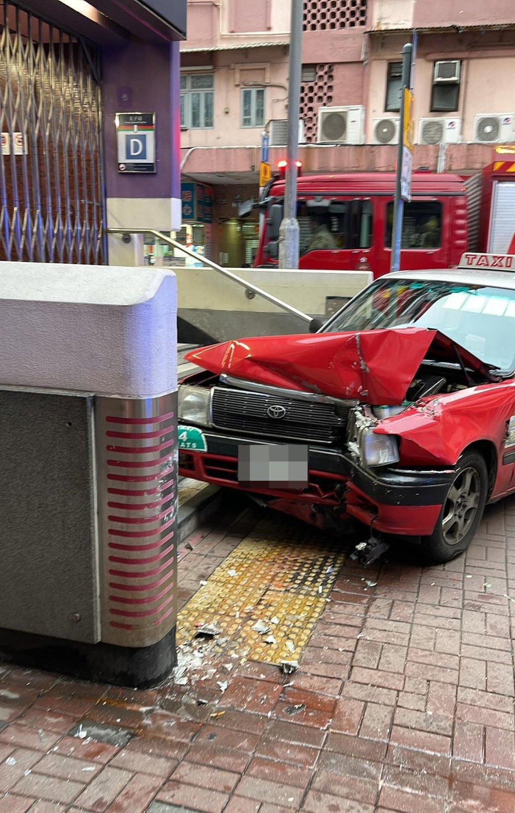 Hong Kong taxi mounts pavement and rams into MTR exit wall, driver ...