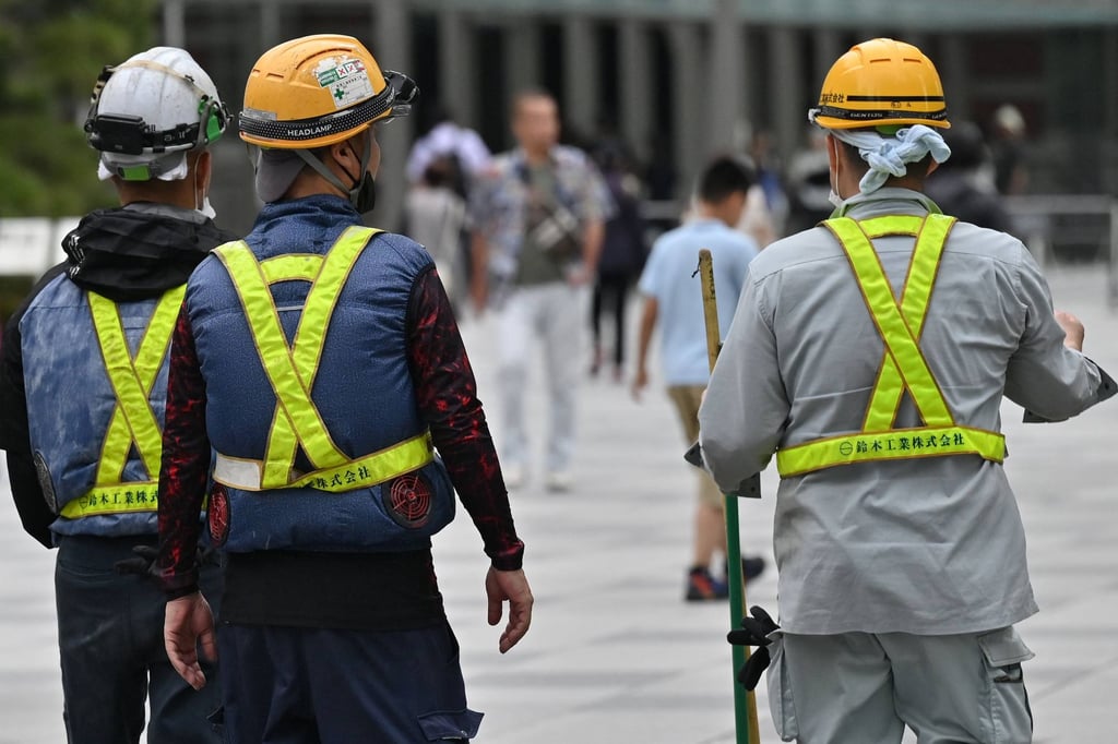 Japanese wear clothes with built-in fans to beat the heat as ...