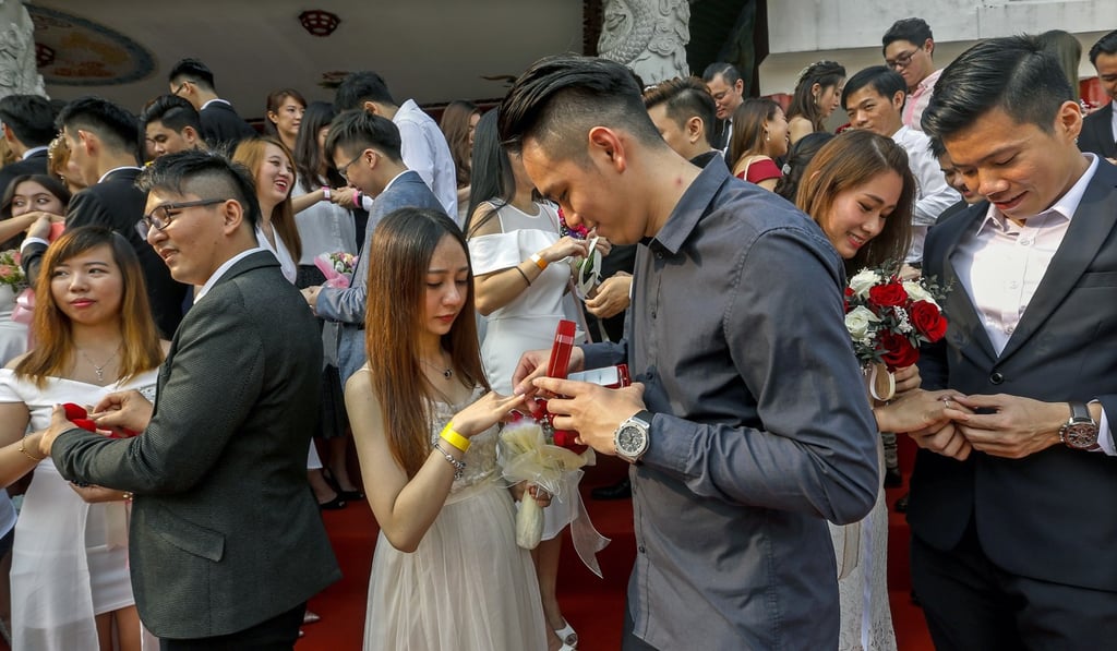 99 ethnic Chinese couples tie knot in Malaysian mass wedding on ...