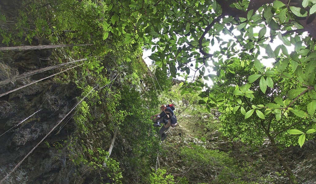 Indonesia cave adventure: 60 metres down a rope is an ancient mini ...