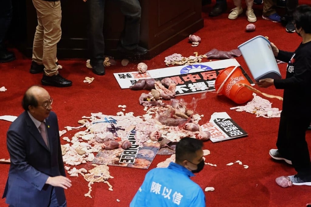 Fists and pig guts fly and opponents hog the floor in Taiwan parliament ...