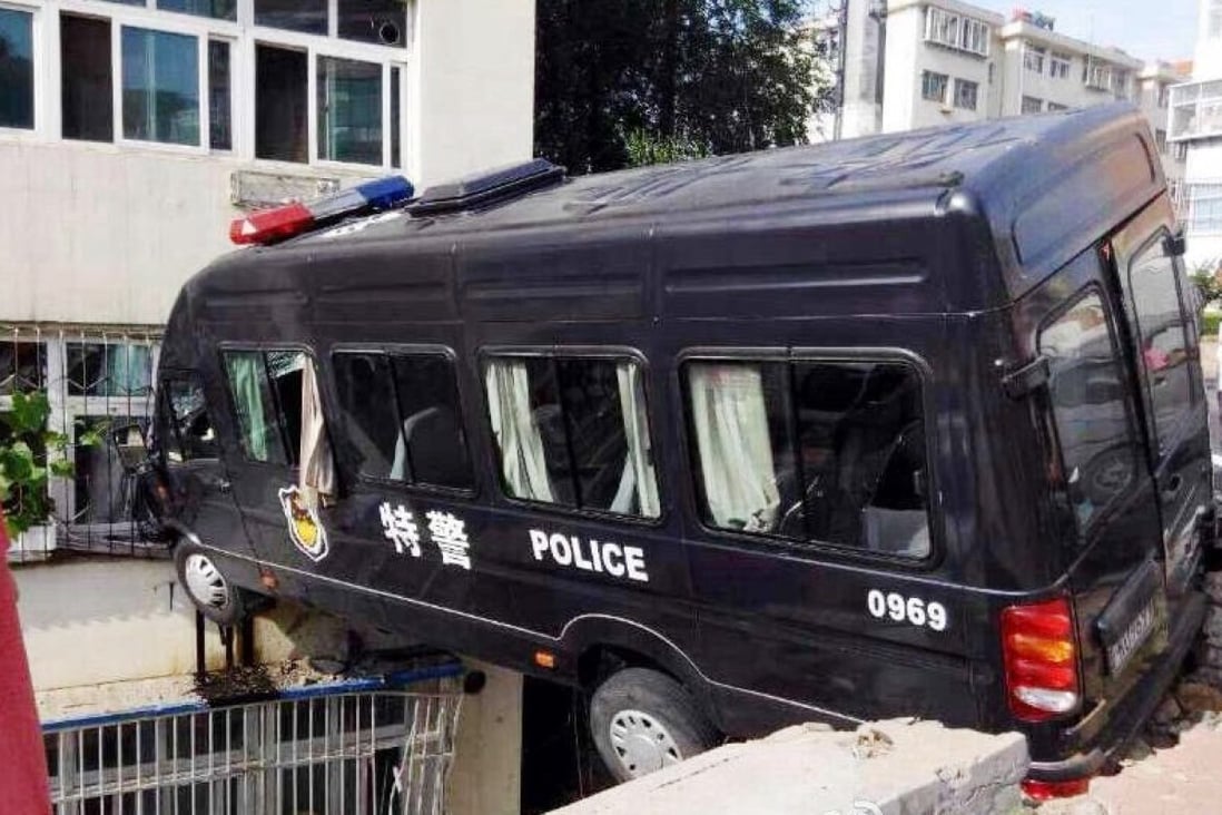 Send in the flying squad! Chinese SWAT car stuck in mid-air after ...