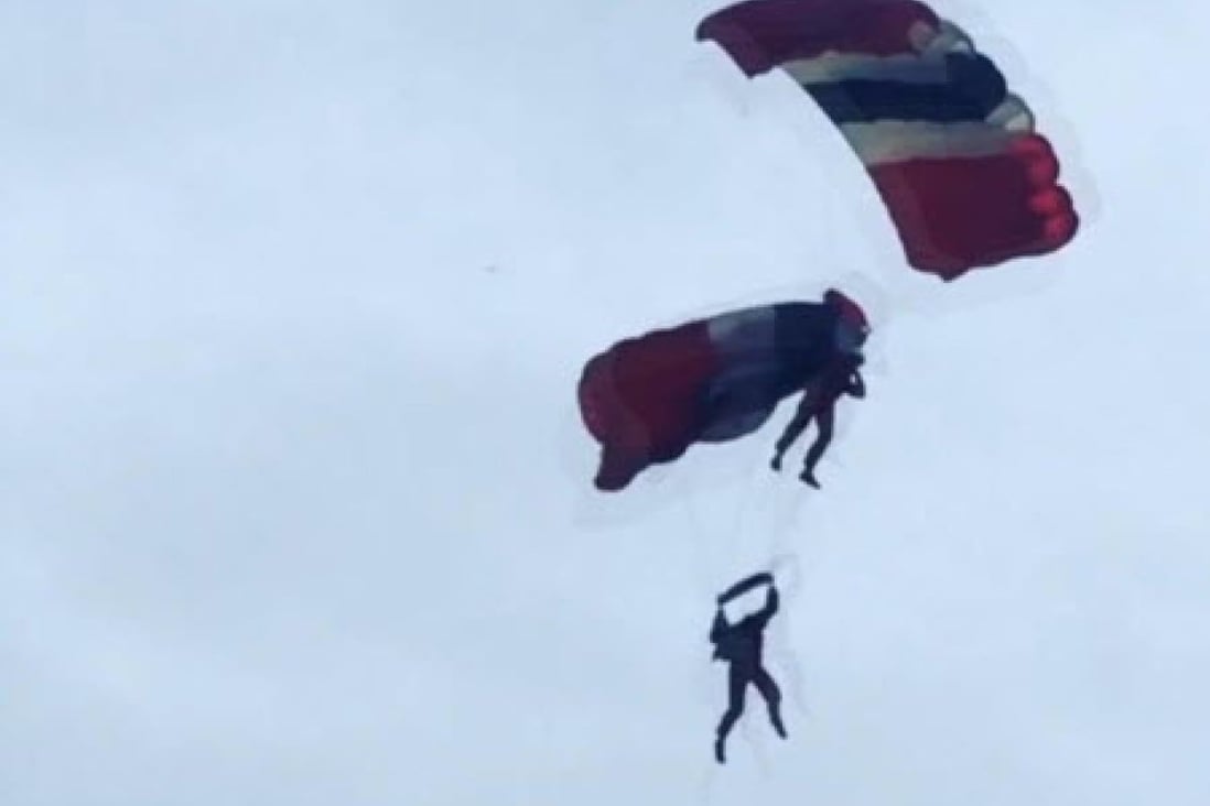 Moment Red Devil paratrooper was caught mid-air by team member when his ...