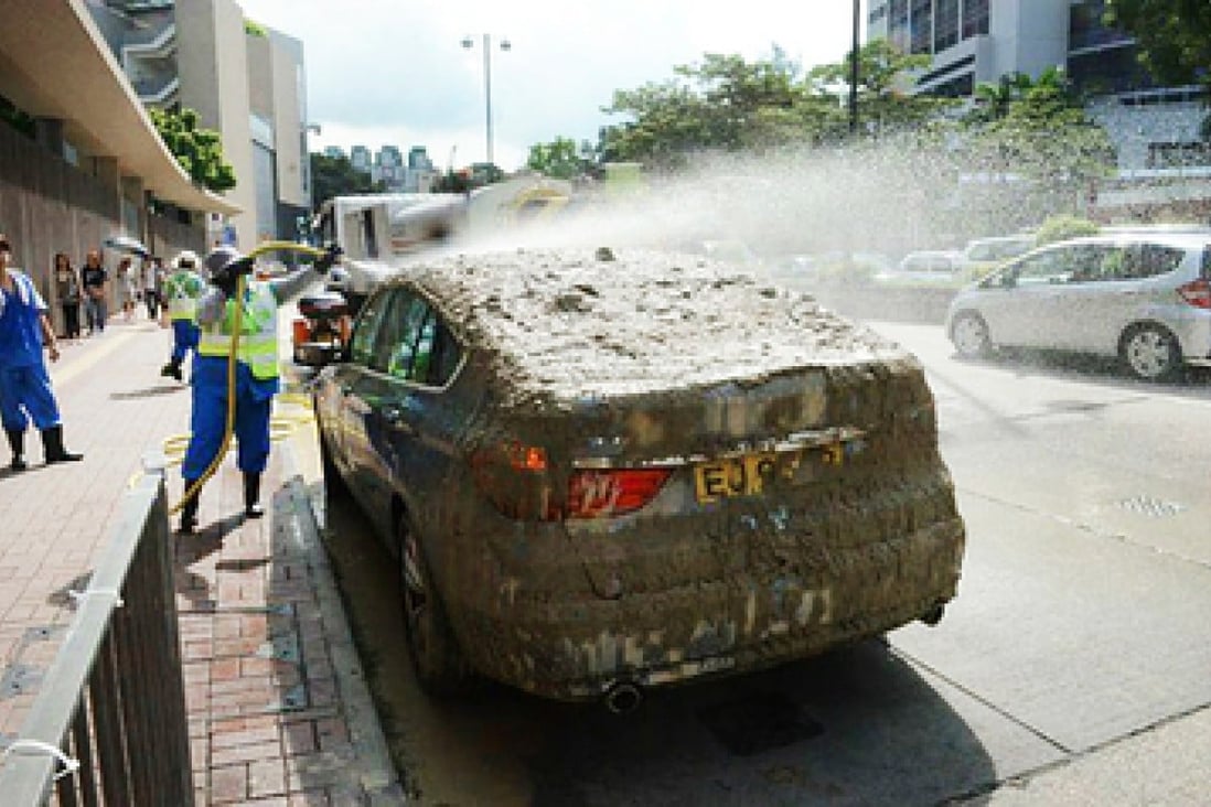 ‘Mud bath’ for luxury BMW car in Hong Kong rush hour as truck dumps its ...