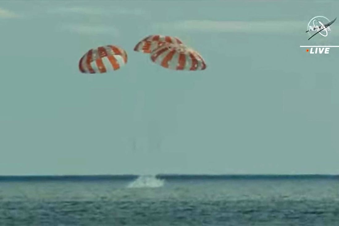 Nasa’s Orion capsule blazes home from test flight to moon, splashing ...