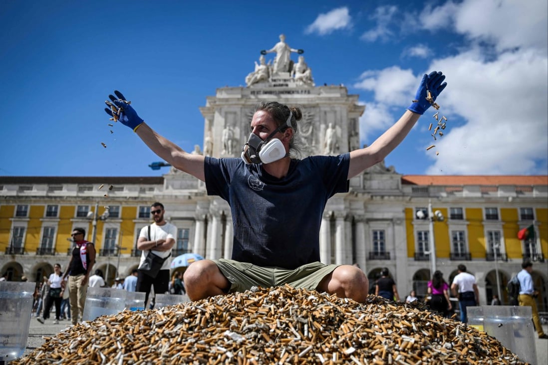 Climate activists pile up 650,000 cigarette butts in Portugal to raise ...