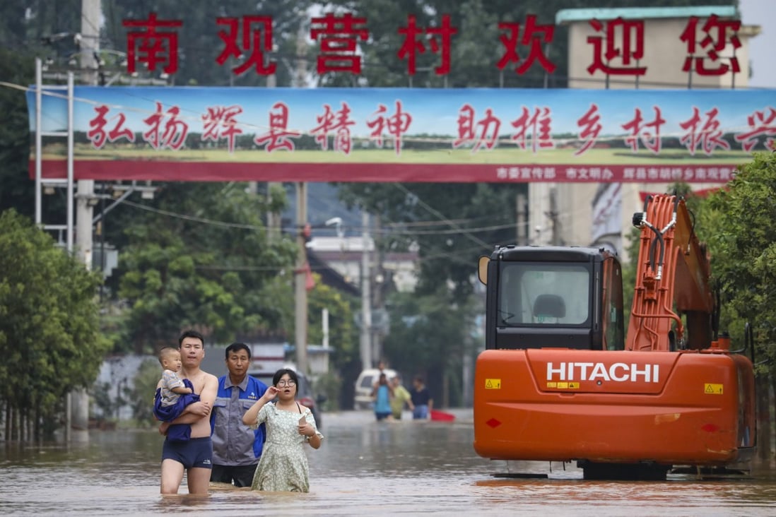 Desperate villagers in central China wade through waist-high floods to ...
