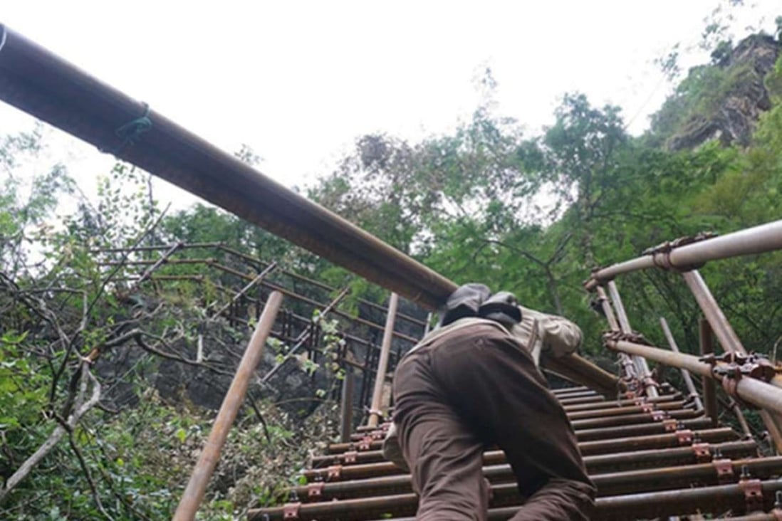 Village on cliff in China builds steel ladder to connect with valley ...