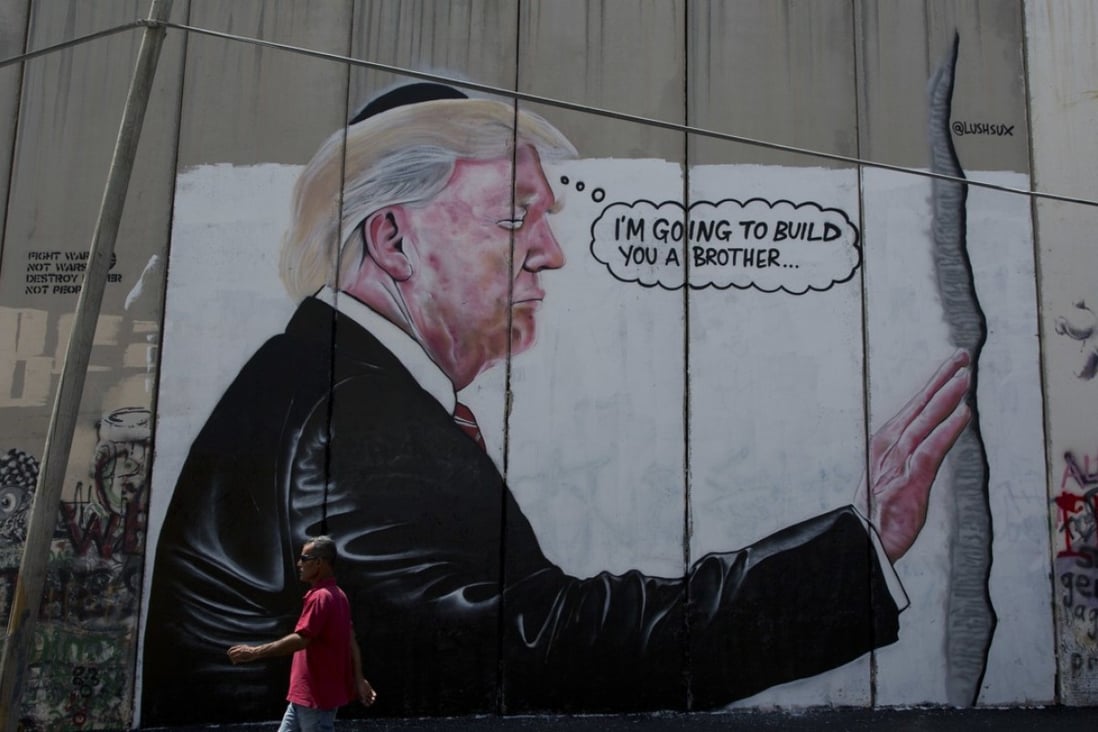 Banksy strikes again? Two giant murals taking aim at Donald Trump ...