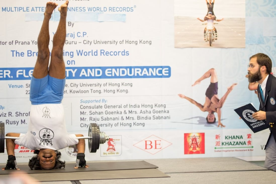 Hong Kong yogi breaks Guinness World Records for headstand and human ...