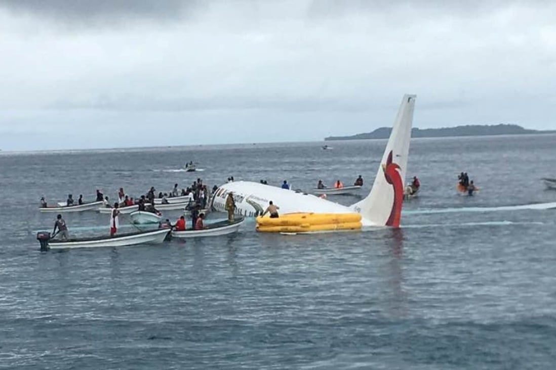 Papua New Guinea plane overshoots Micronesia runway and sinks in lagoon ...