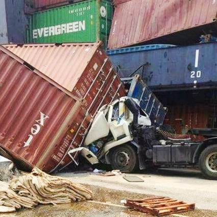 Unconscious driver pulled from truck crushed by tumbling shipping ...