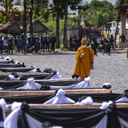 Thai families gather for mass cremation of nursery massacre victims ...