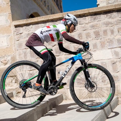 Top Iranian mountain biker in fight against US sanctions to get to ...