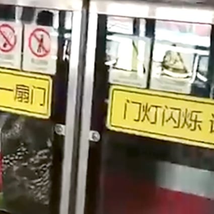 Chinese woman trapped behind subway safety doors as train speeds by ...